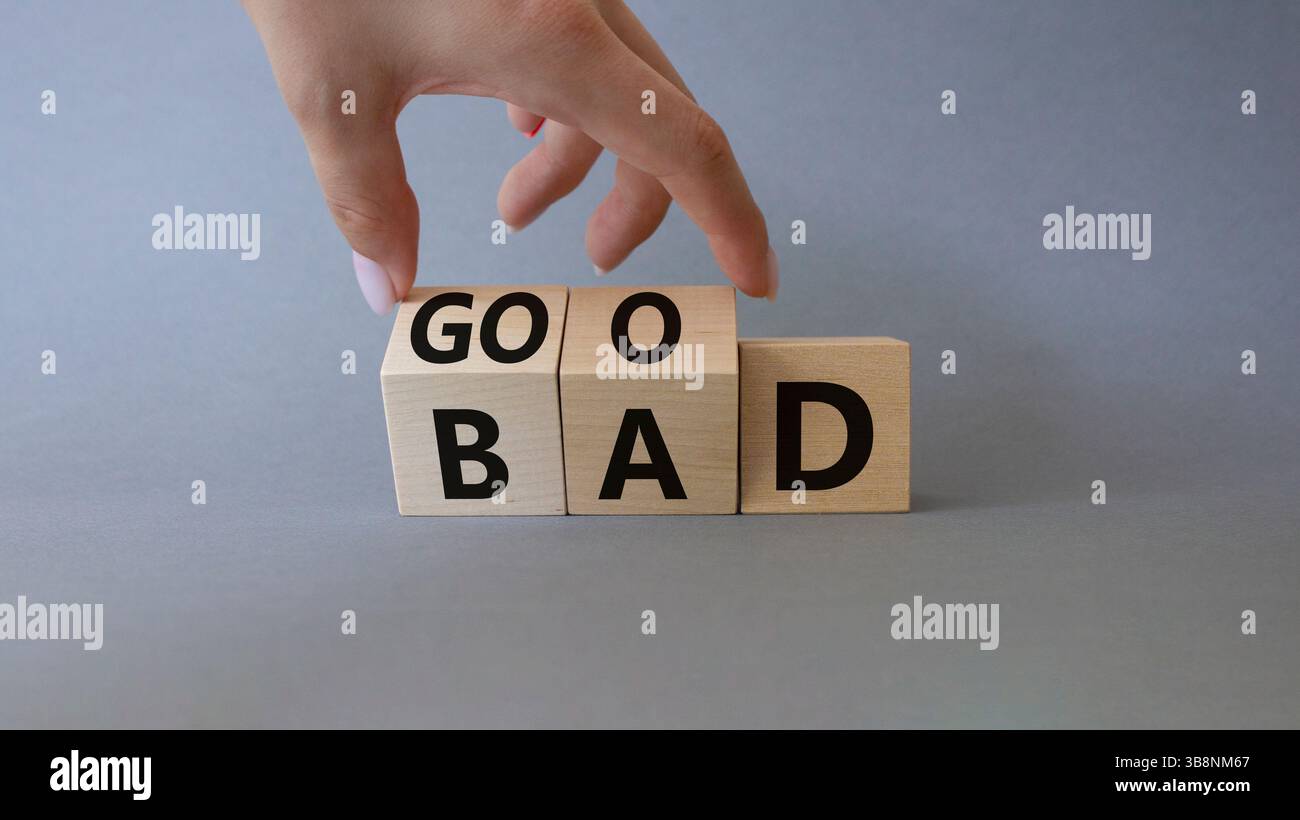 Good vs Bad symbol. Businessman Hand turns cubes and changes word Bad ...