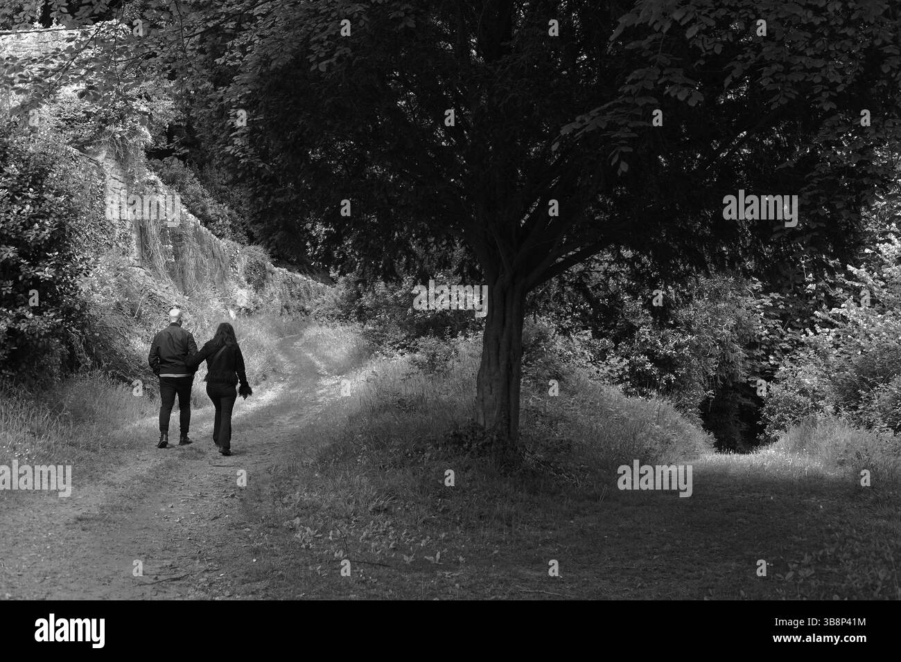 Man woman walking along path Black and White Stock Photos & Images - Alamy
