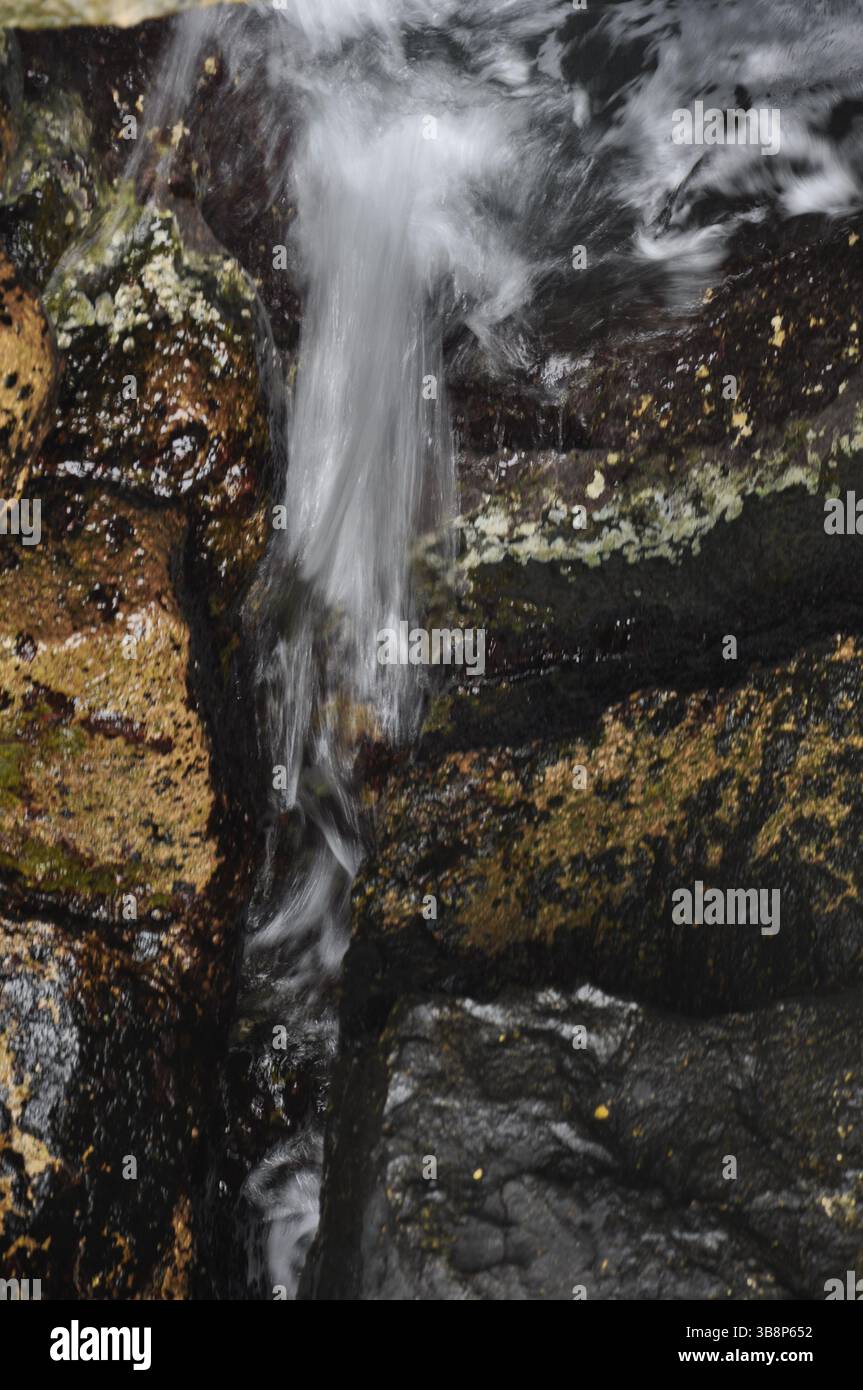 Waterfall flowing between rocks hi-res stock photography and images - Alamy