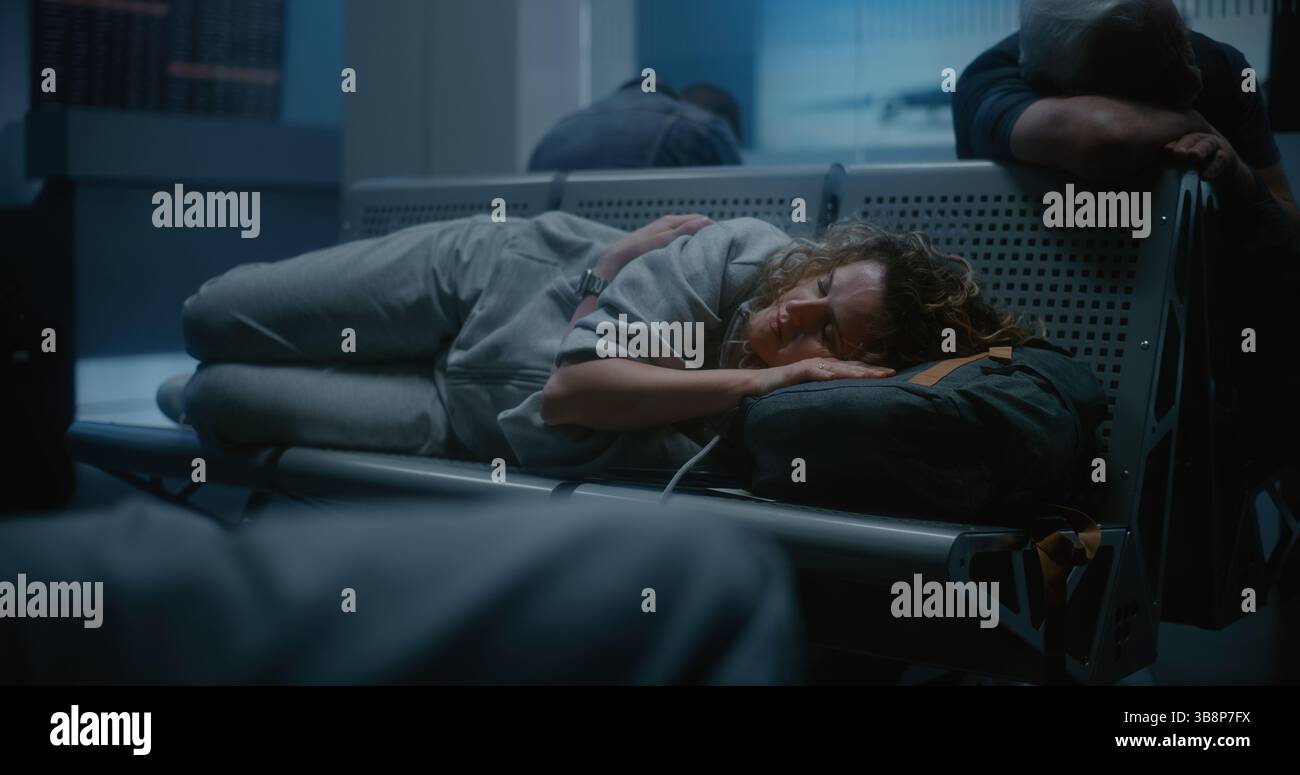 Crowded International Airport Terminal: Tired Woman Sleeping on Backpack on the Seats in ...