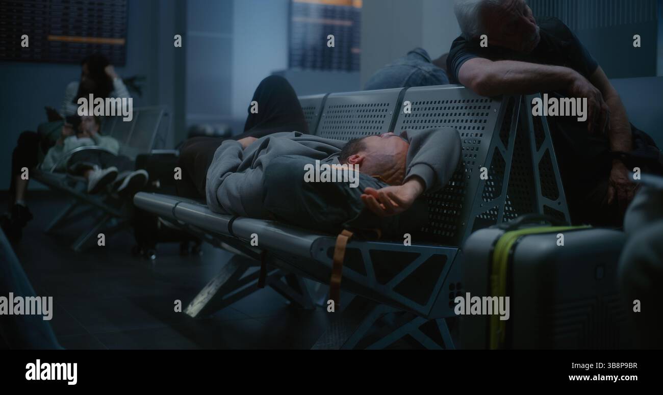 Crowded International Airport Terminal: Tired Man Sleeping on Backpack ...