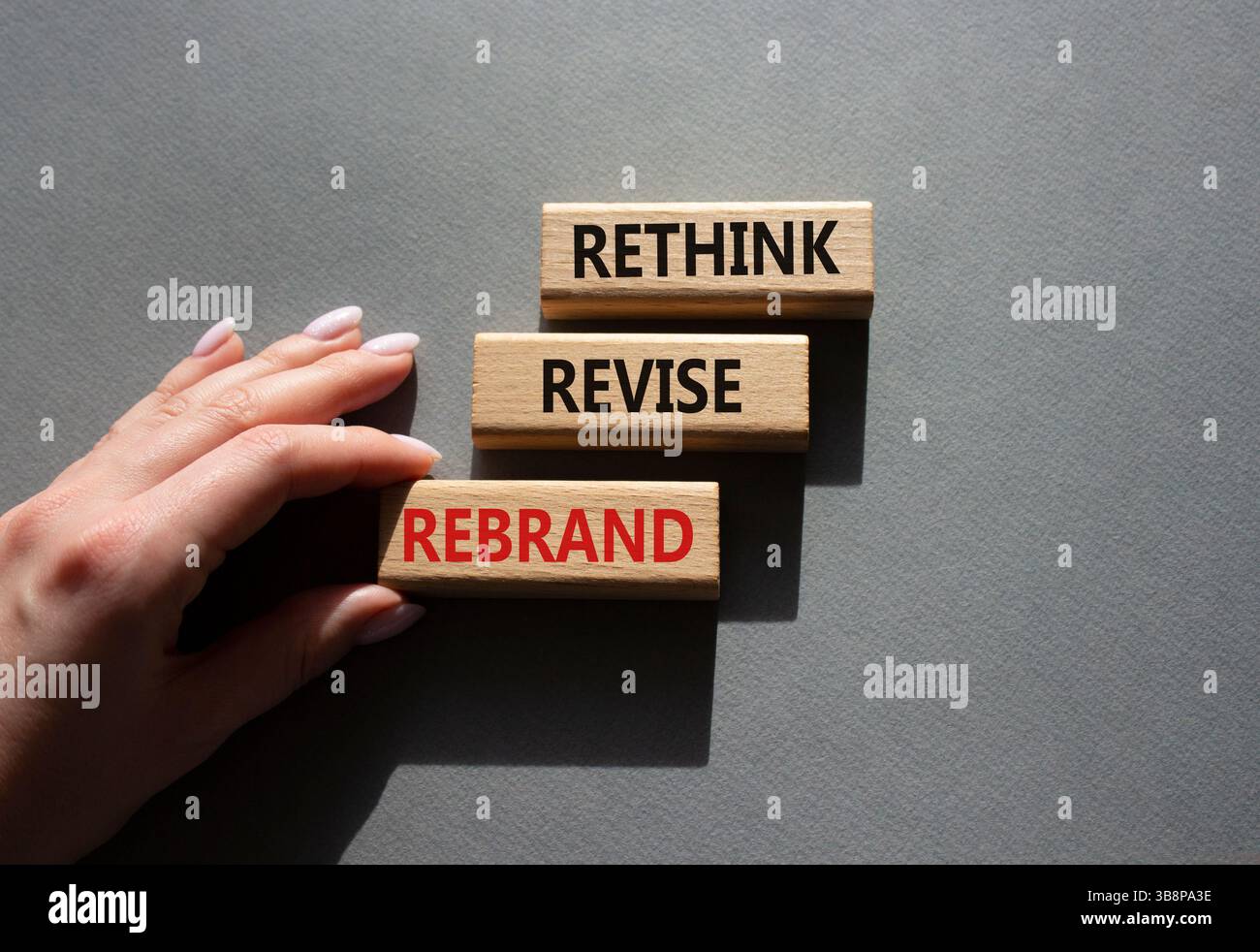 Rethink Revise Rebrand symbol. Wooden blocks with words Rethink Revise Rebrand. Beautiful grey ...