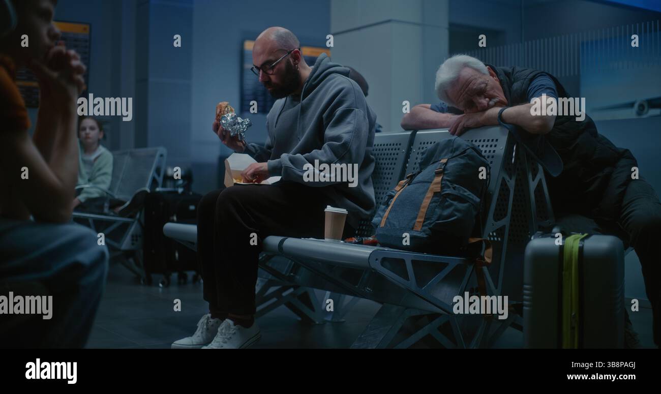 Departure lounge night man eating hi-res stock photography and images ...