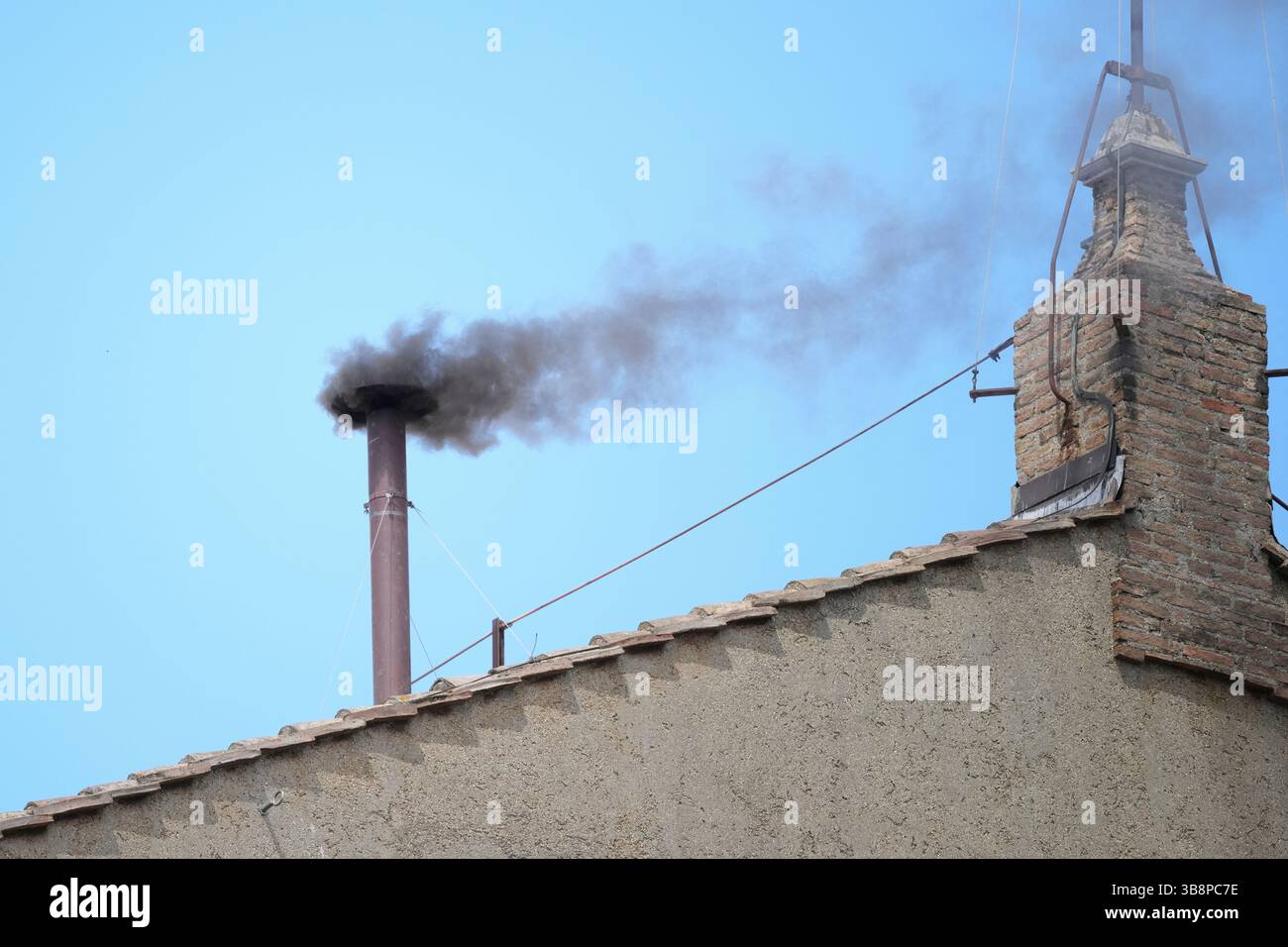 smoke billows from the chimney of the Sistine Chapel during the ...