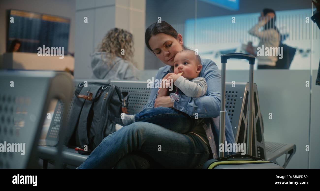 Crowded International Airport Terminal: Adult Woman Feeding Infant ...