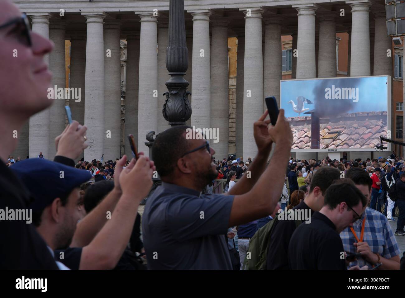 Faithful take photos the black smoke billows from the Sistine Chapel ...
