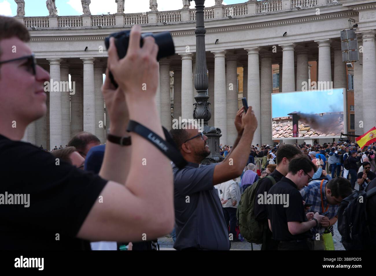 Faithful take photos the black smoke billows from the Sistine Chapel ...