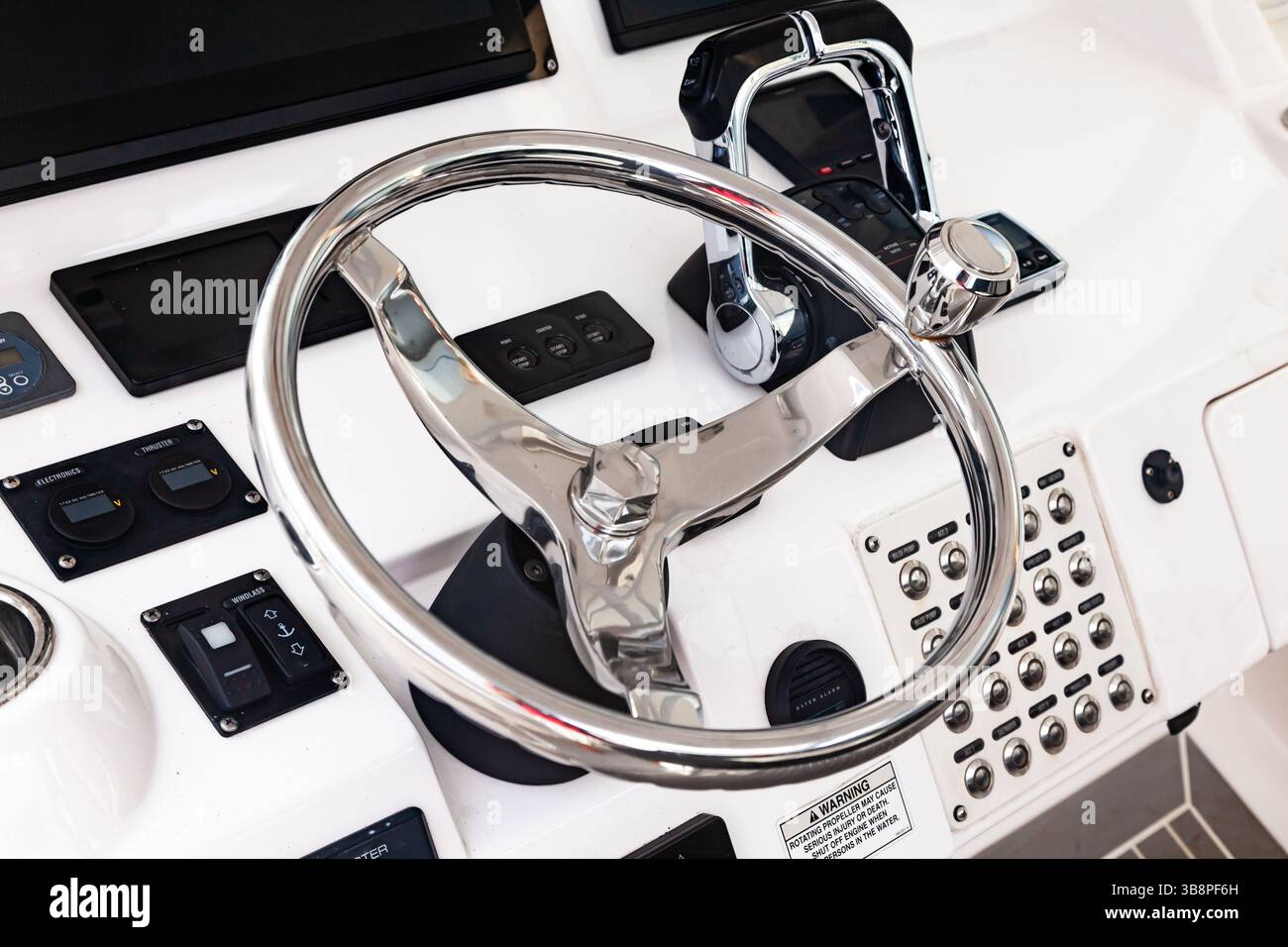 Luxury yacht control panel with steering wheel, gear levers, navigation ...