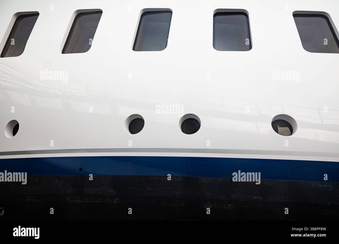 Portholes on the hull of a luxury yacht, above the waterline, side view ...