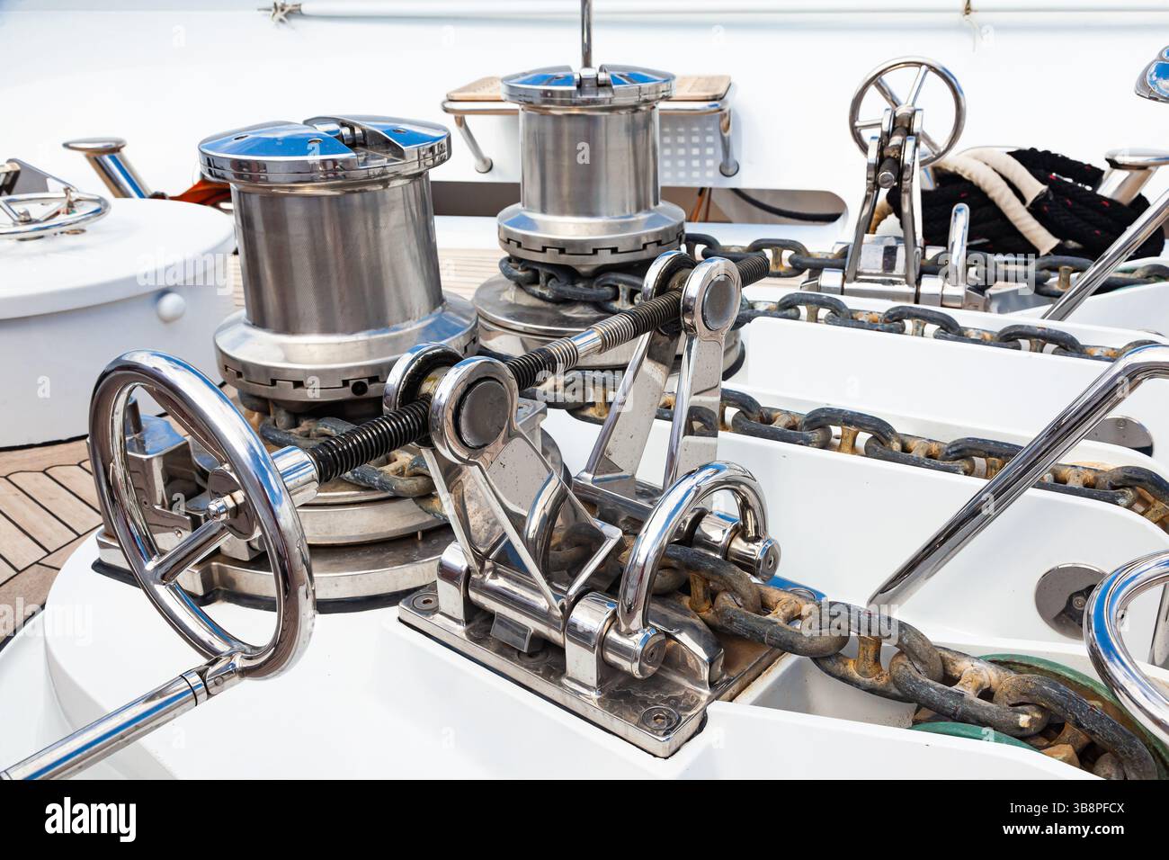 Bow part of the yacht with anchor stops, part of the anchor chain and ...