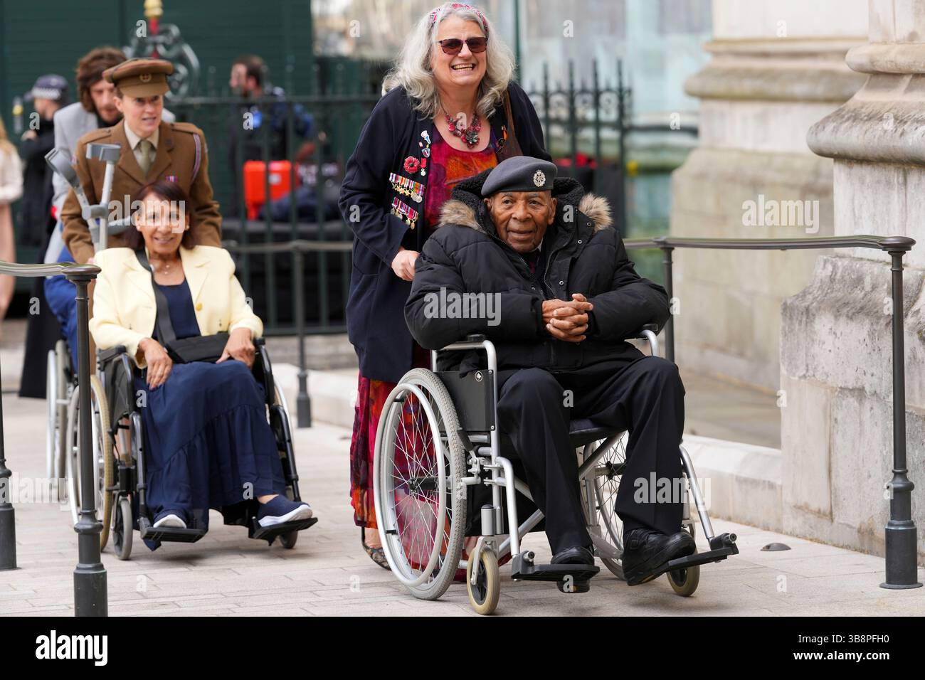 Veteran Gilbert Clarke, right, arrives to attend a Service of ...
