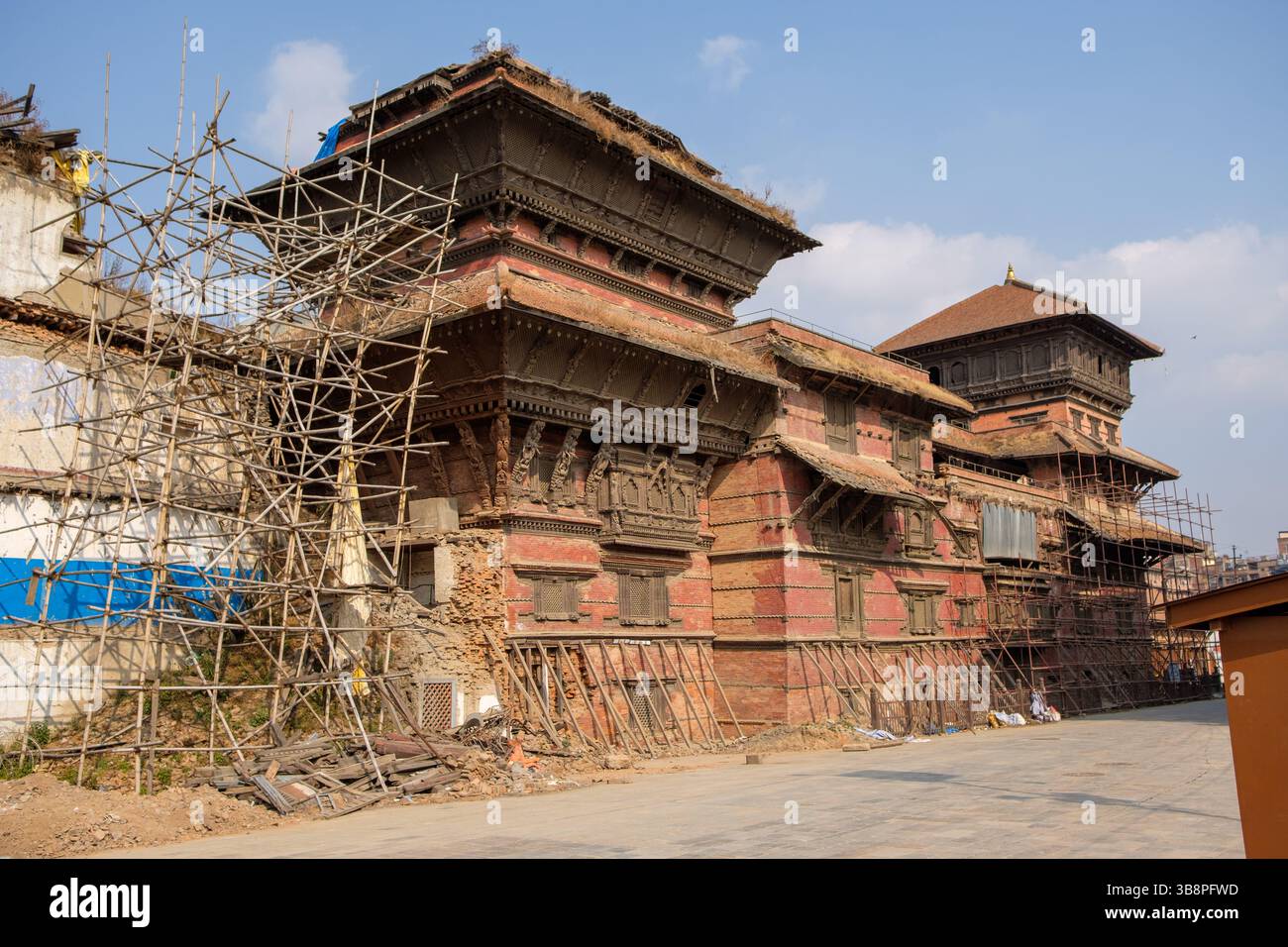 Restoration work underway at a historic building in Nepal after earthquake damage. Scaffolding ...