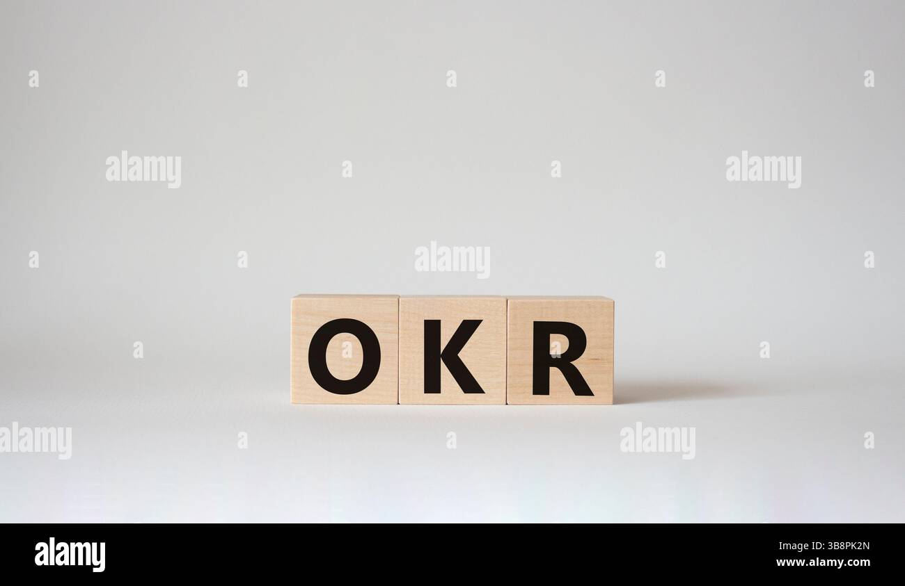 OKR objectives and key results symbol. Wooden cubes with words OKR ...