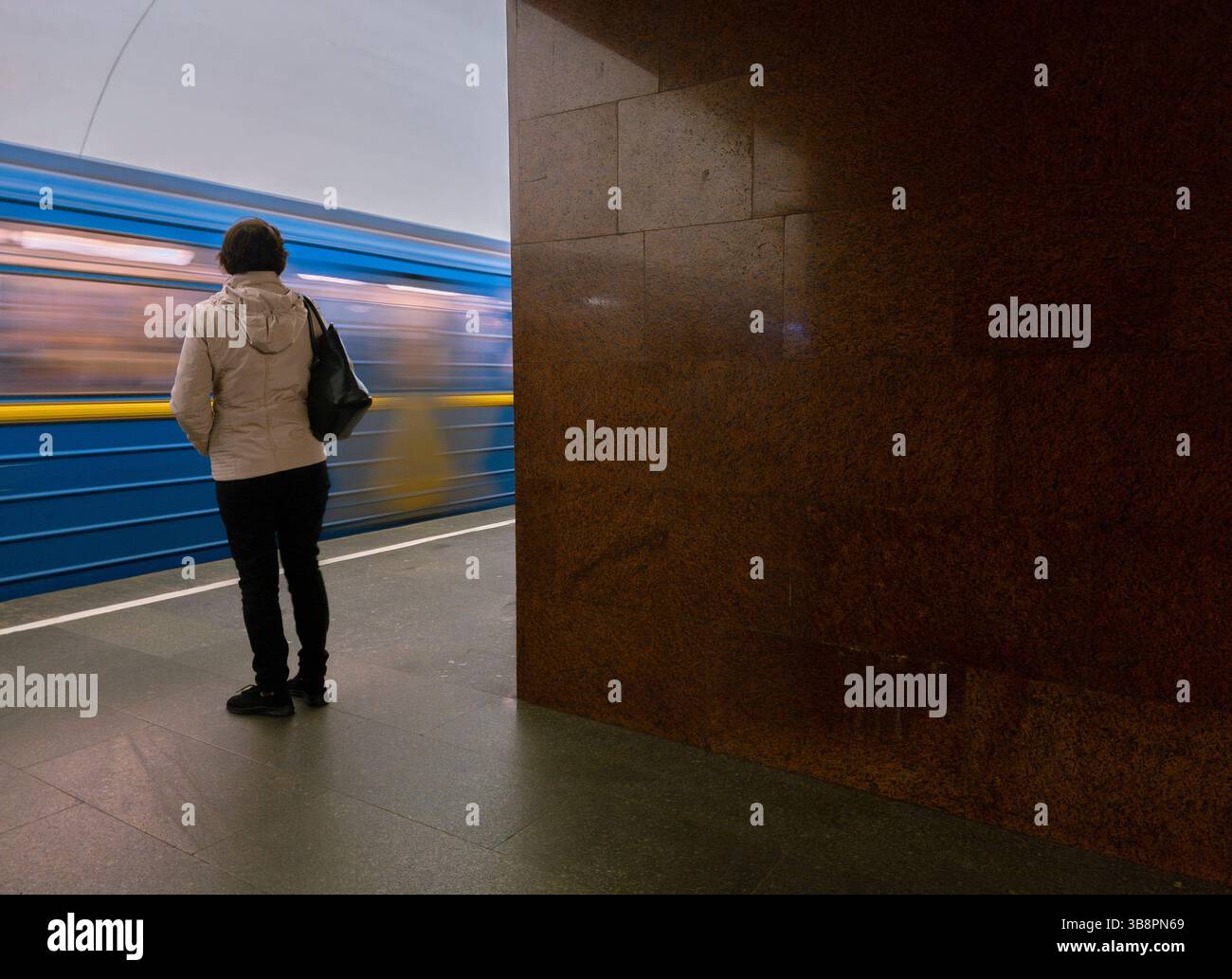 Kyiv, Ukraine - 1st May, 2025, a commuter waits at the subway platform ...