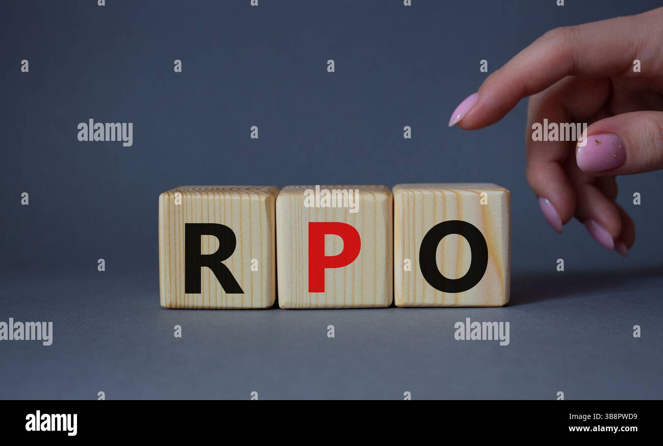 RPO - Recruitment Process Outsourcing symbol. Wooden cubes with words ...