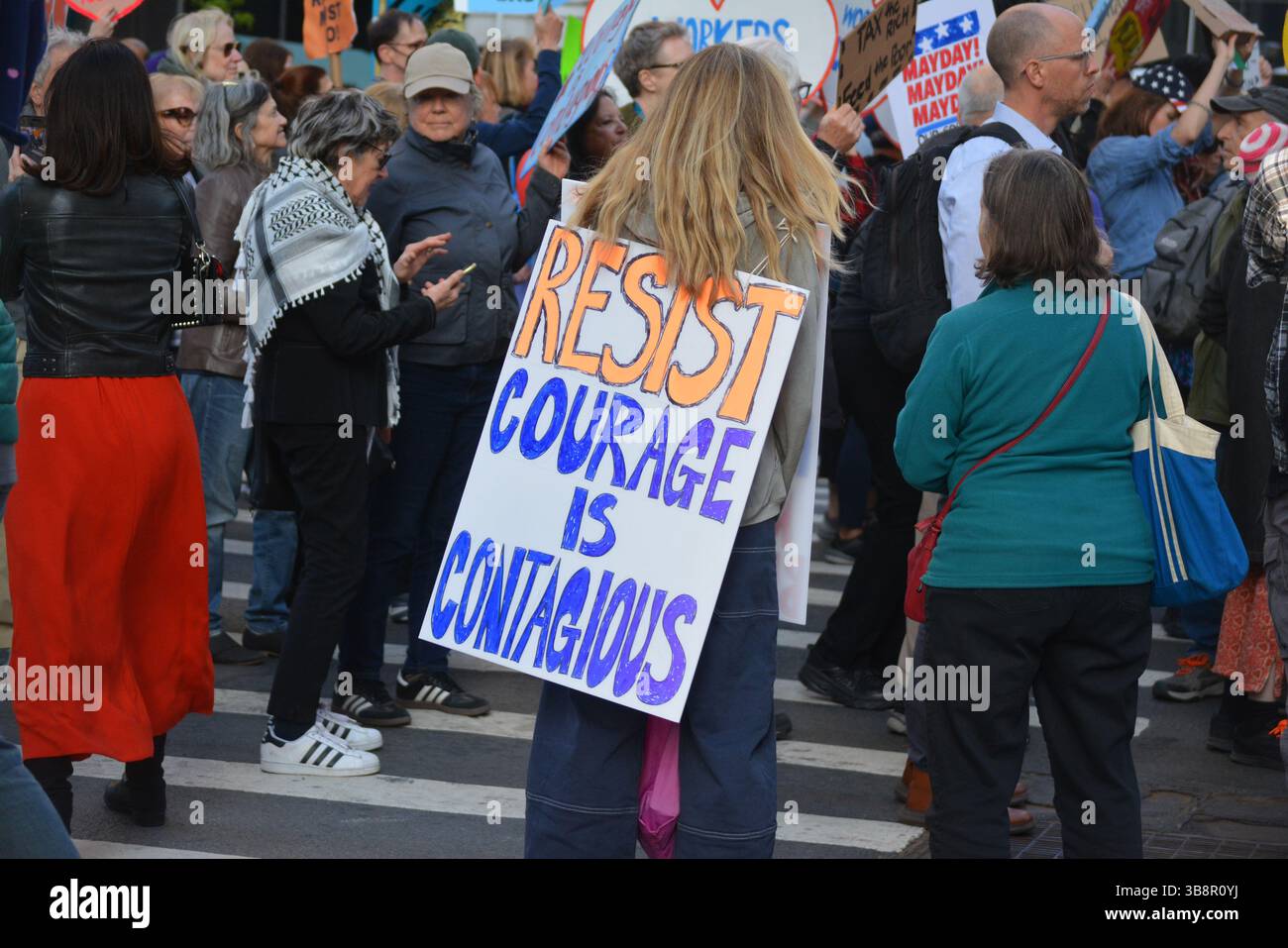 People with signs at a May Day event in Lower Manhattan Stock Photo - Alamy