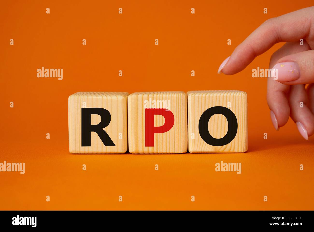 RPO - Recruitment Process Outsourcing symbol. Wooden cubes with words ...
