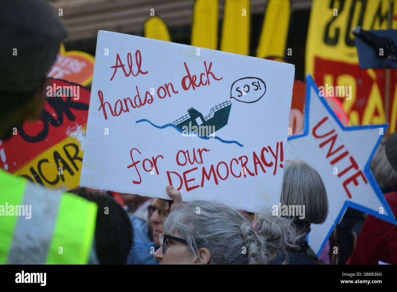 People with signs at a May Day event in Lower Manhattan Stock Photo - Alamy