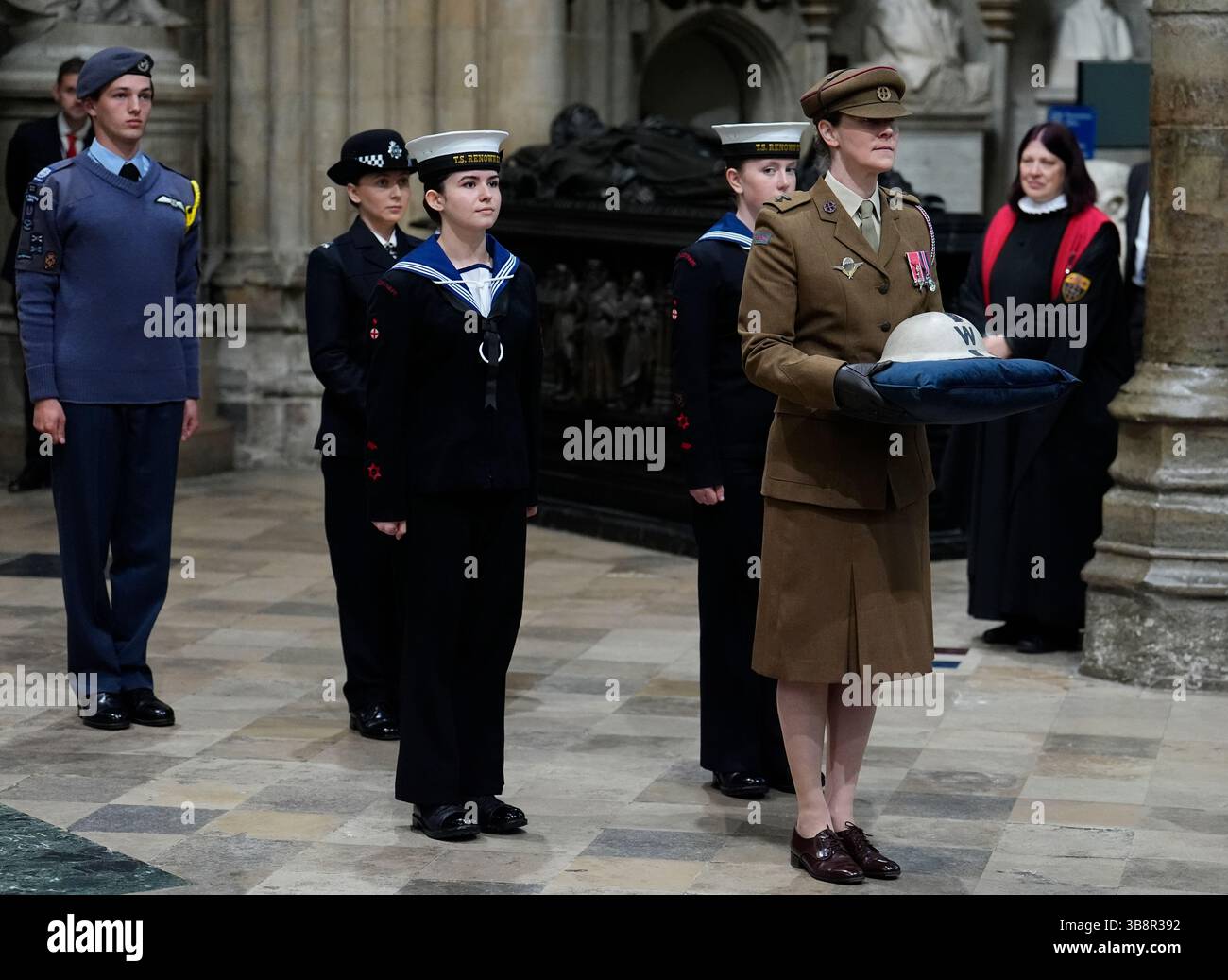 An Air Raid Warden helmet is carried to the High Altar by a member of ...