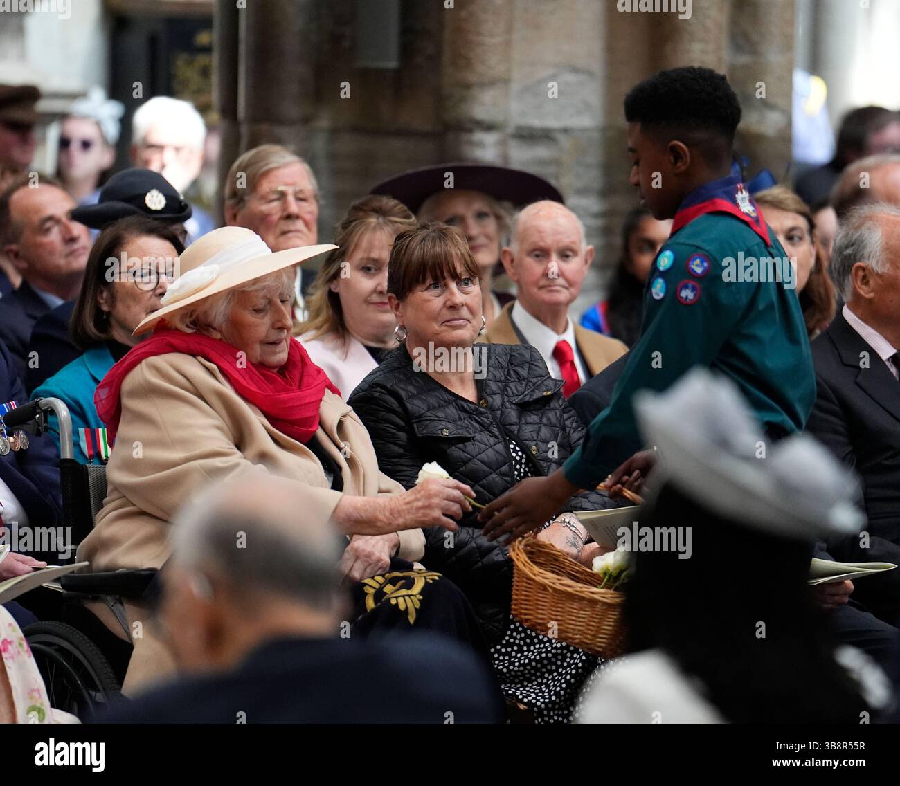 A Scout distributes white roses to Second World War veterans during a ...