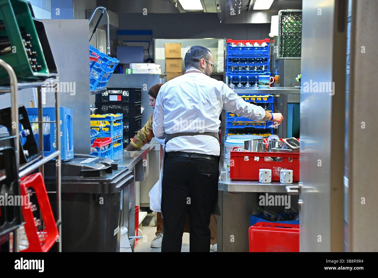 Foreign kitchen assistants in a restaurant kitchen. Working as ...