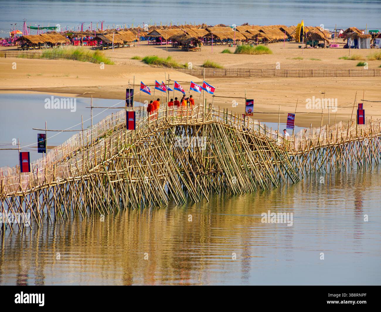 Buddhist monks walk over the bamboo bridge between Kampong Cham and ...