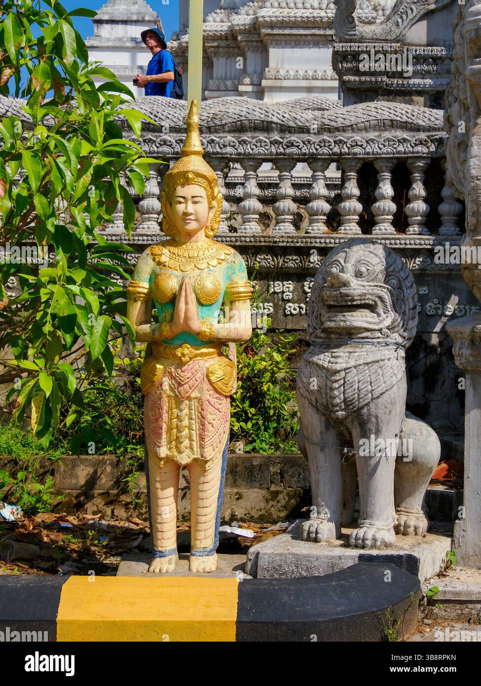 Statues of a female guard and large dog greet visitors to Phnom Bros ...