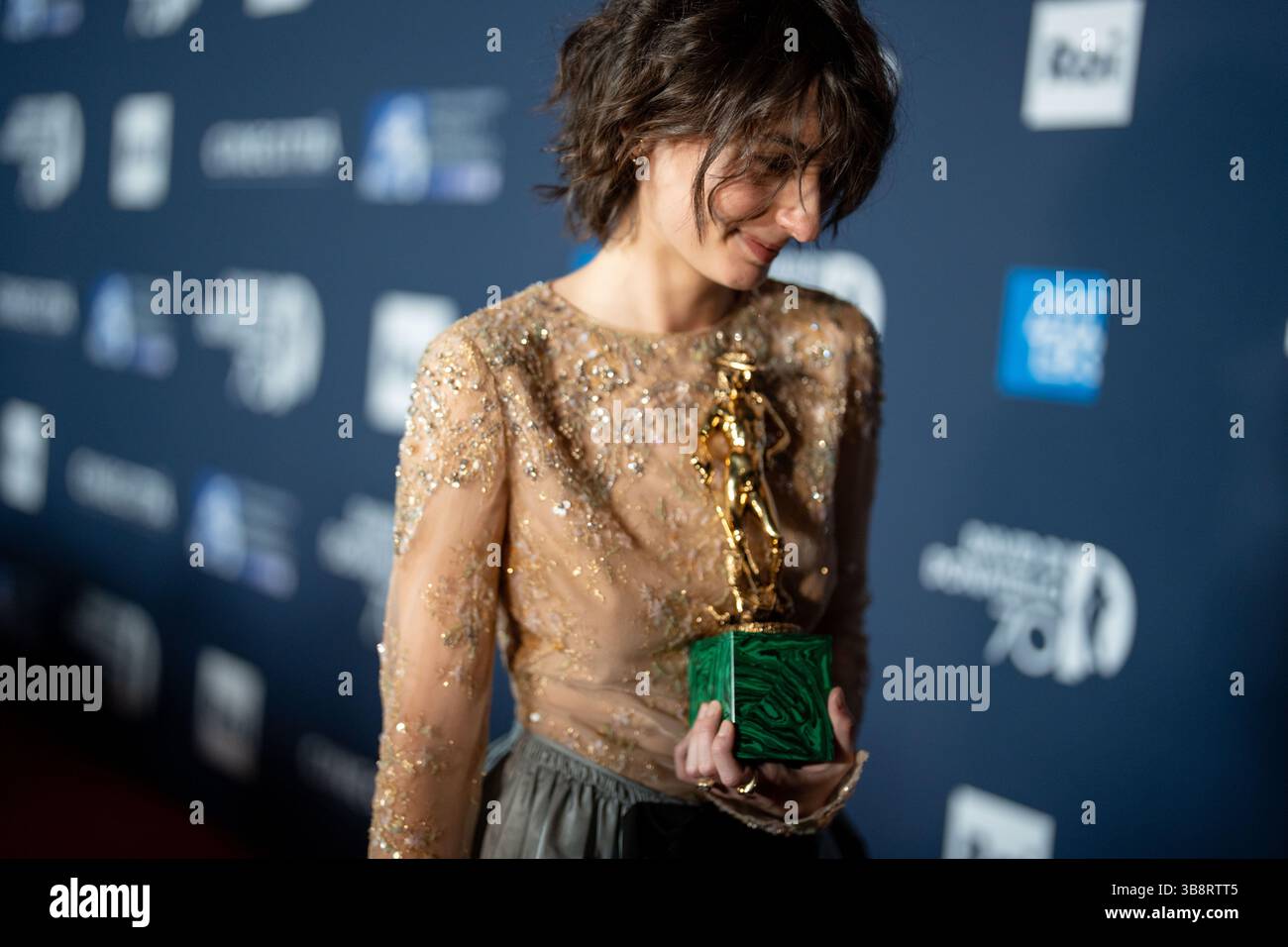 Tecla Insolia with the Best Actress Award attends the photocall during ...