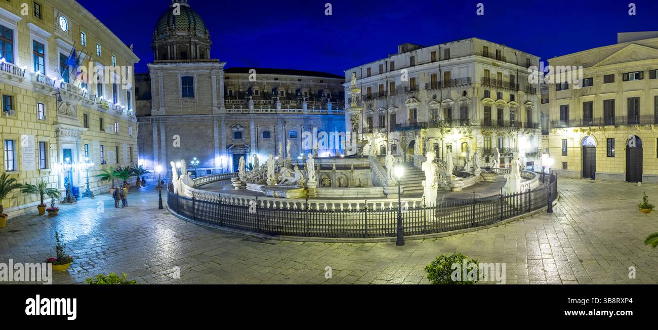 Night view of the Fontana Pretoria in Palermo, Sicily. Tourists admire ...