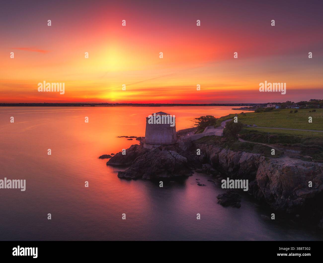 Colourful sunset sky and a sun pillar over Sutton Martello Tower Stock ...