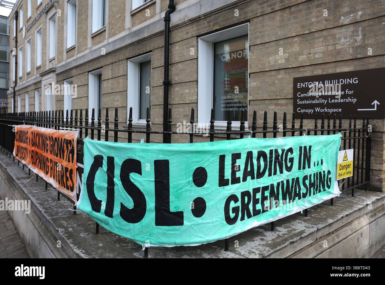 Cambridge, England, UK. 8th May, 2025. Protesters leave a banner tied ...