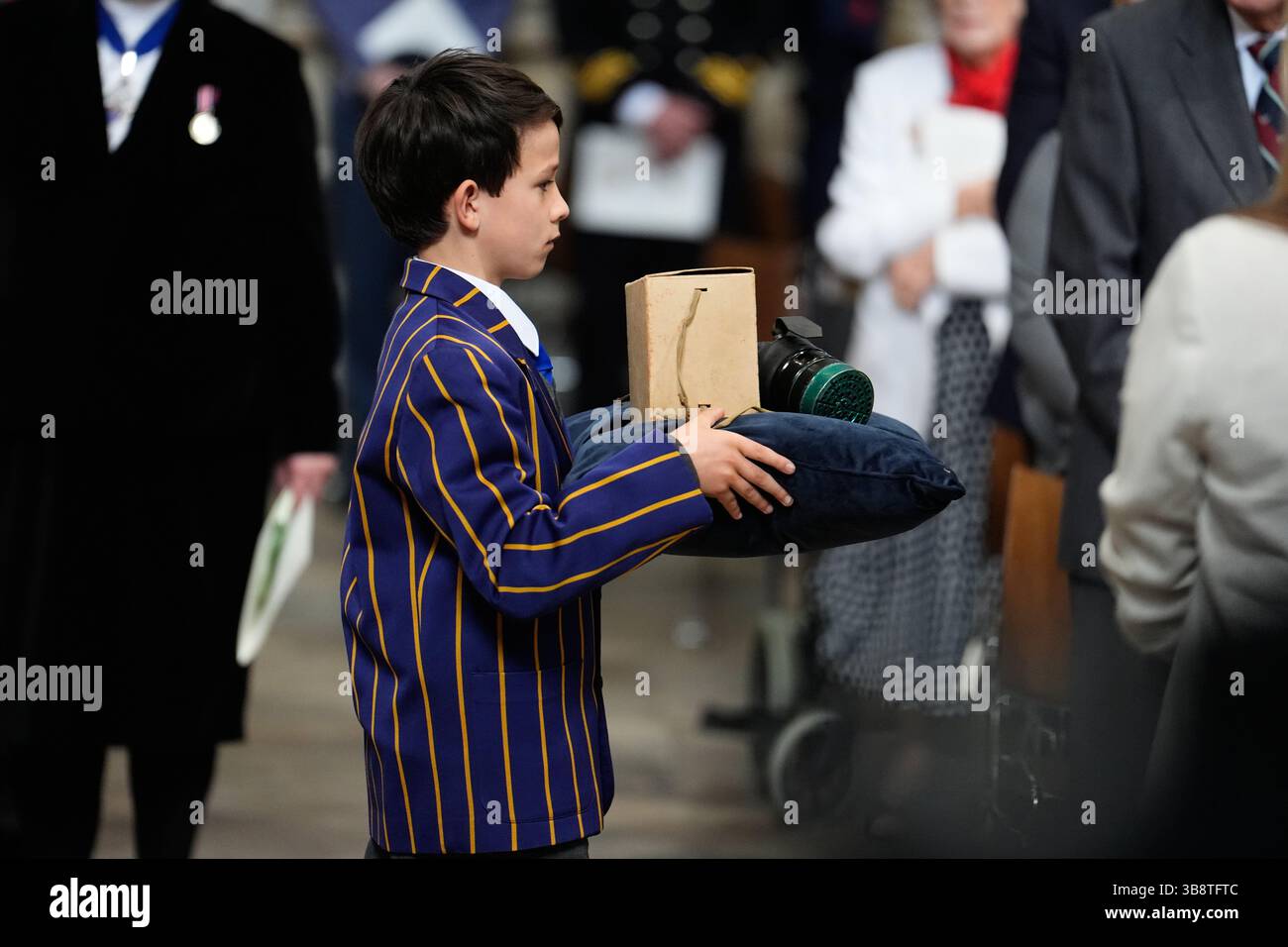 A child's gas mask and box is carried to the High Altar by a pupil ...
