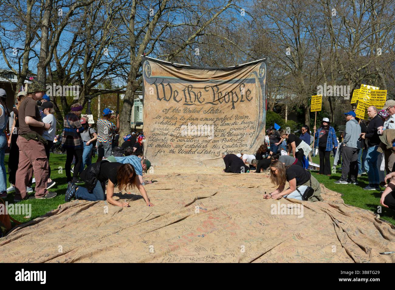 Supporters sign their names to a monumental Backbone Campaign banner in ...