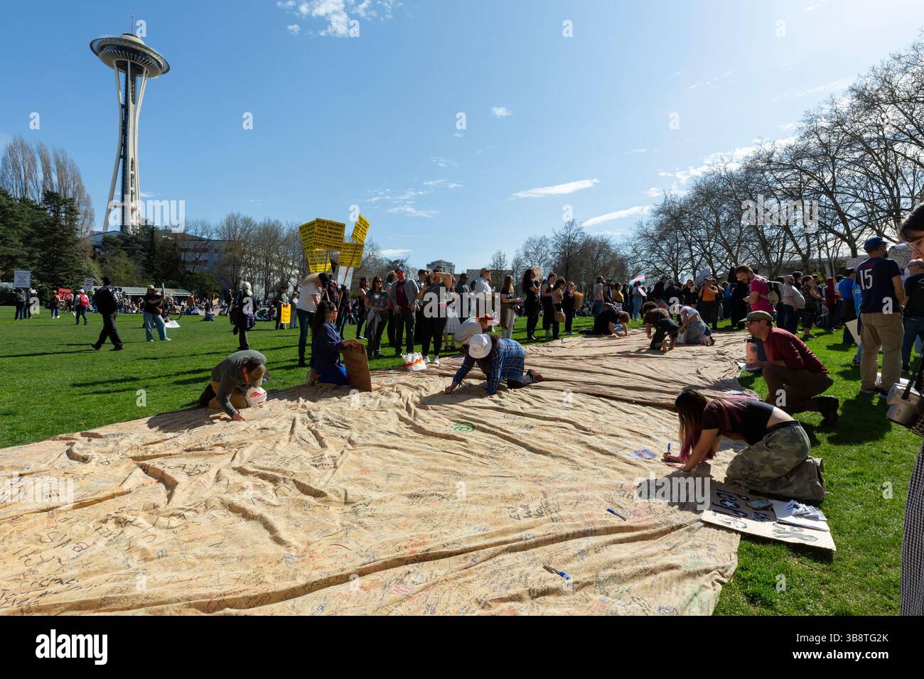 Supporters sign their names to a monumental Backbone Campaign banner in ...