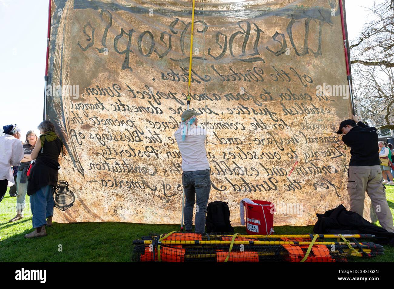 Volunteers with the Backbone Campaign prop up a monumental banner in ...