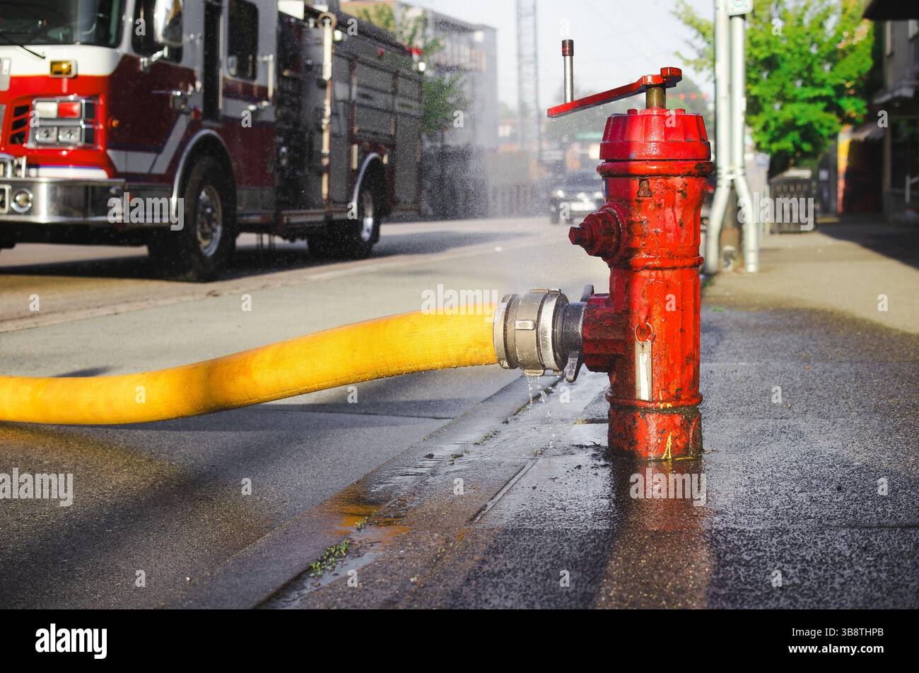 Fire hydrant with hose attached hi-res stock photography and images - Alamy