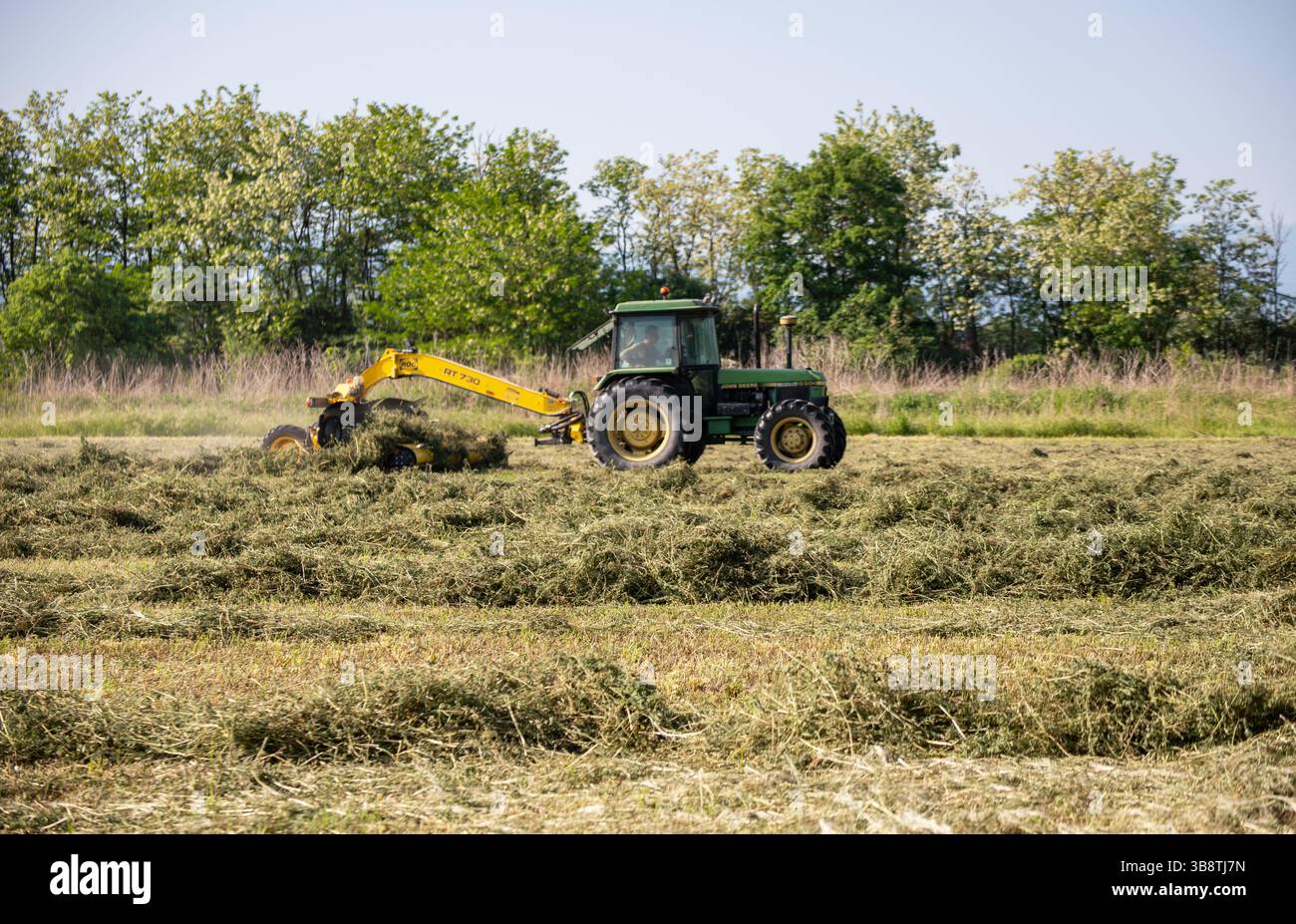 Agricultural tractor cutting grass farm vehicle hay production ...