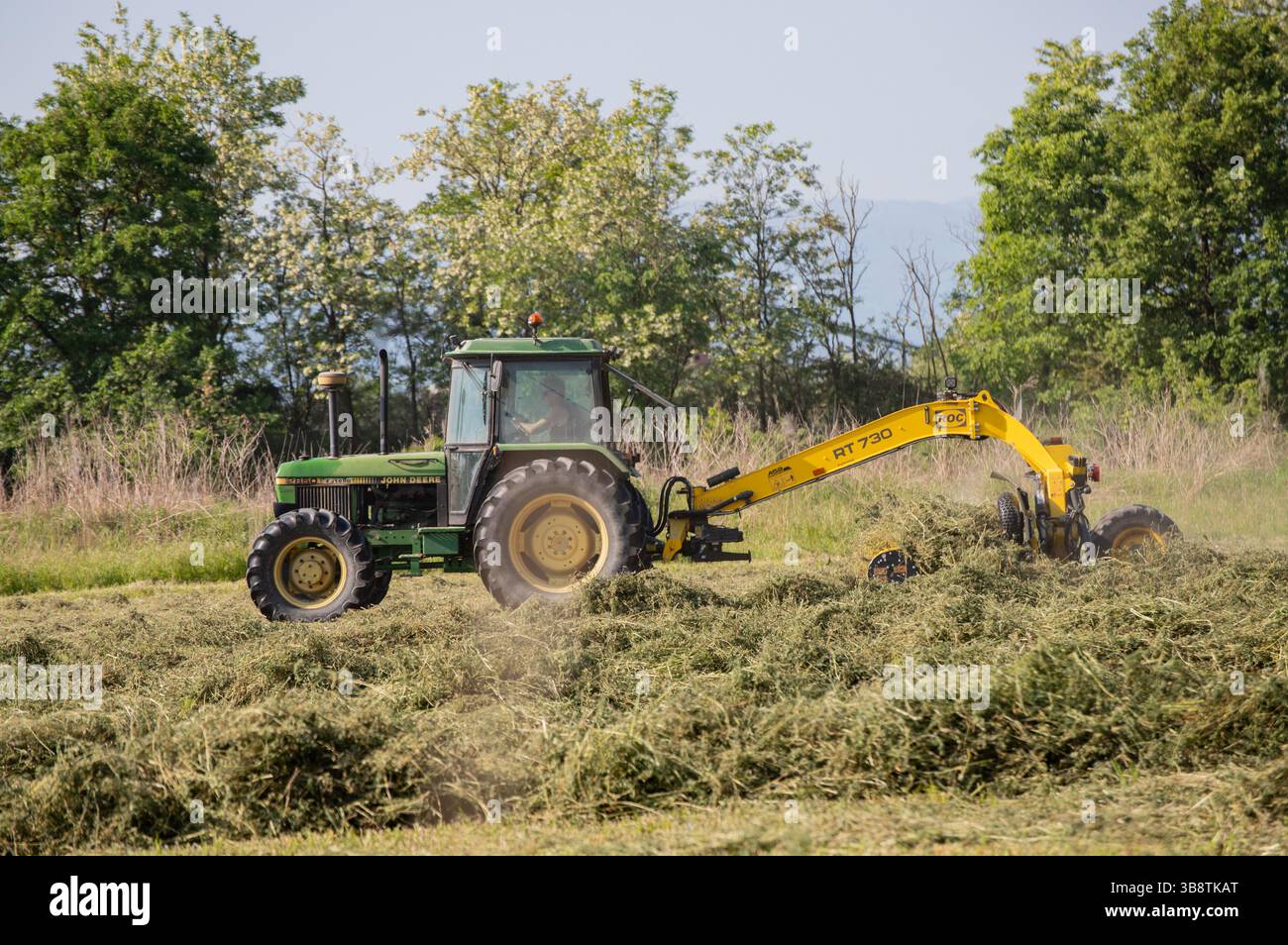 Agricultural tractor cutting grass farm vehicle hay production ...