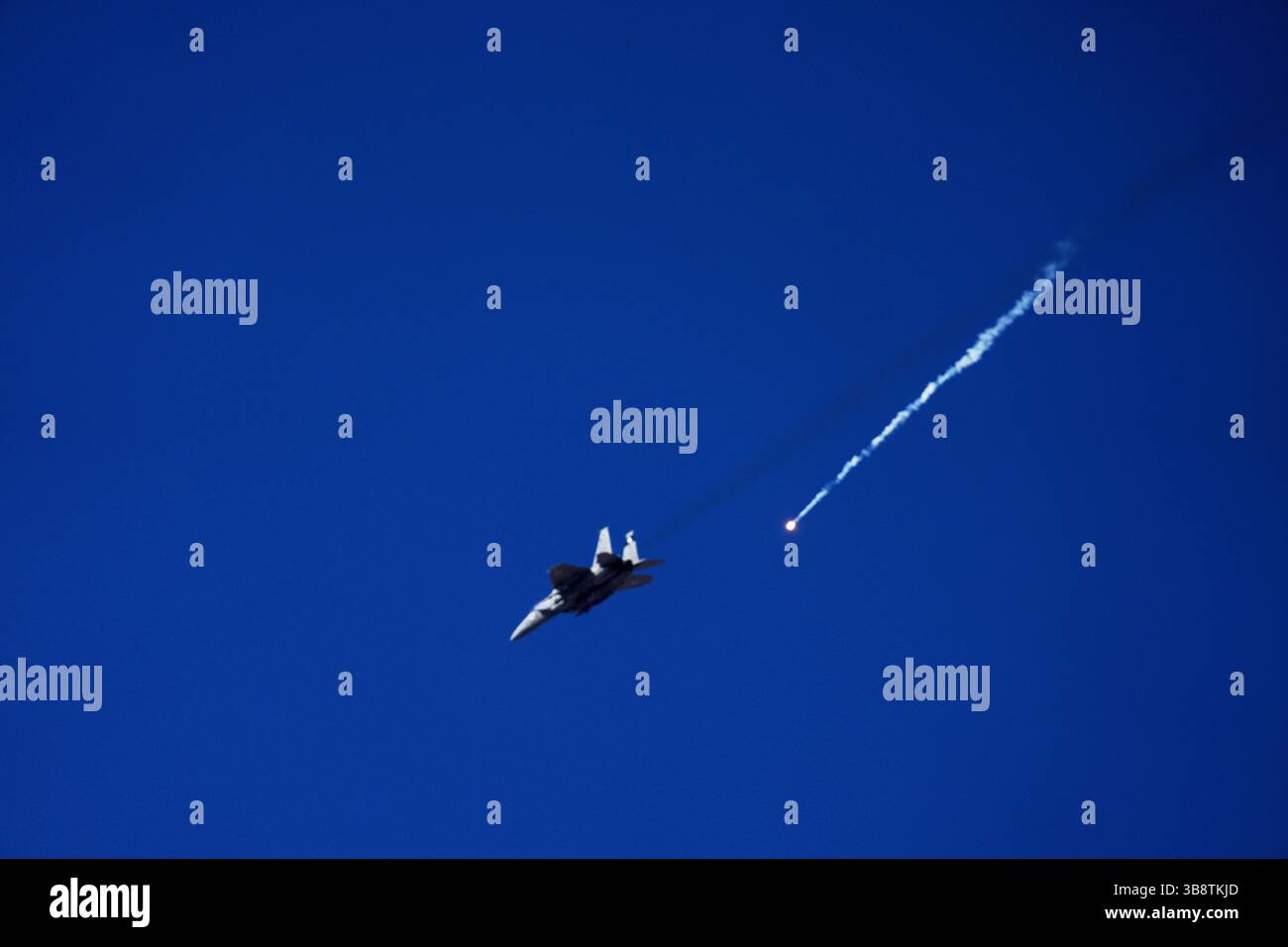 An Israeli Air Force fighter jet releases flares over the Gaza Strip ...
