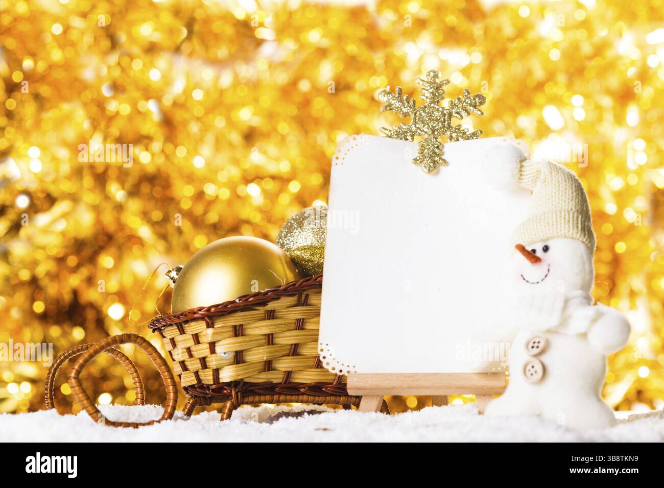 Christmas greetings with snow, snowman and sledge over gold sparkle ...