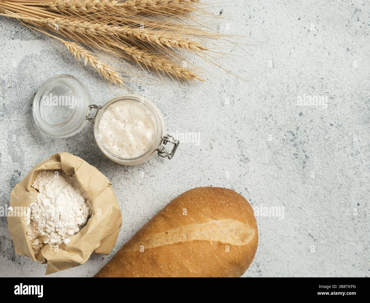 Wheat sourdough starter. Top view of bread making ingredients - glass ...