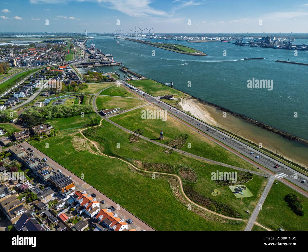Aerial view of a coastal town with green parks, residential areas, a ...