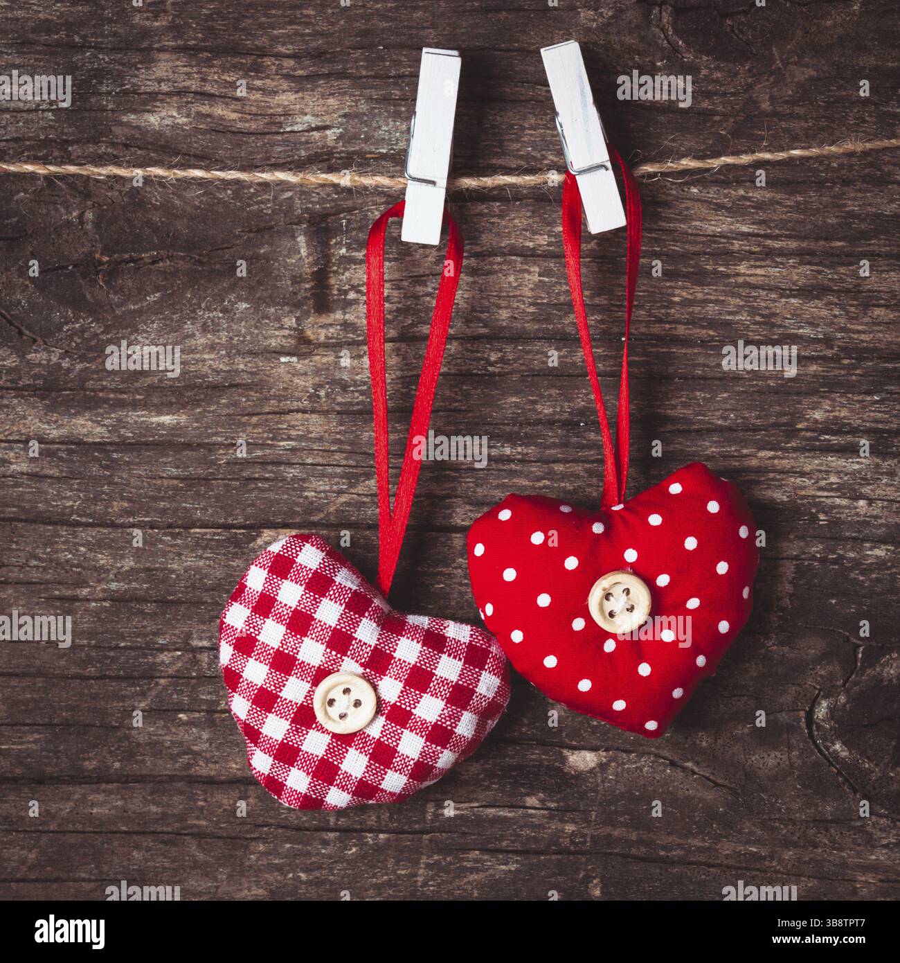 Two hearts .attached to the rope. Valentine greetings Stock Photo - Alamy