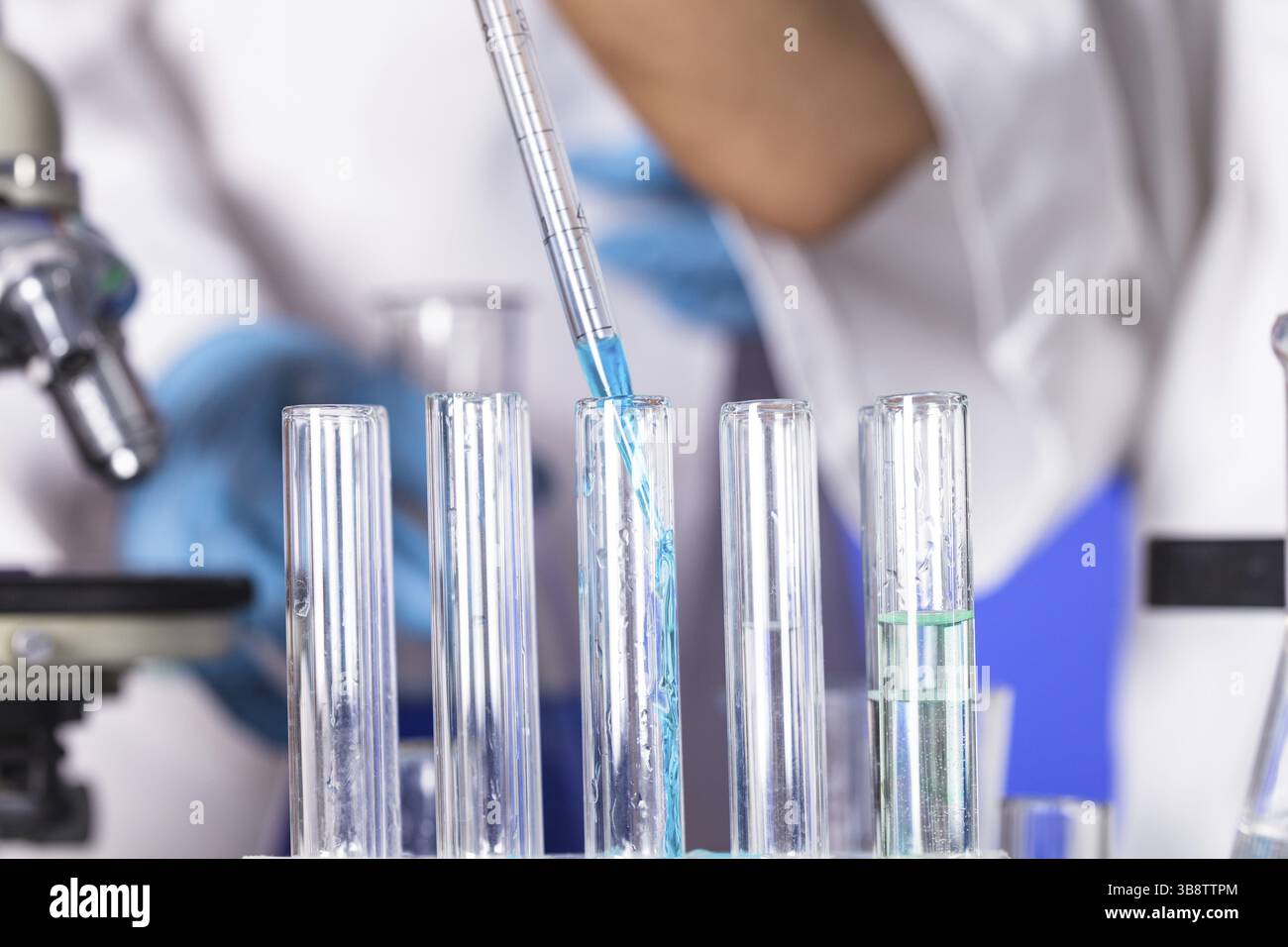 The blue drop from pipette in laboratory tubes Stock Photo - Alamy