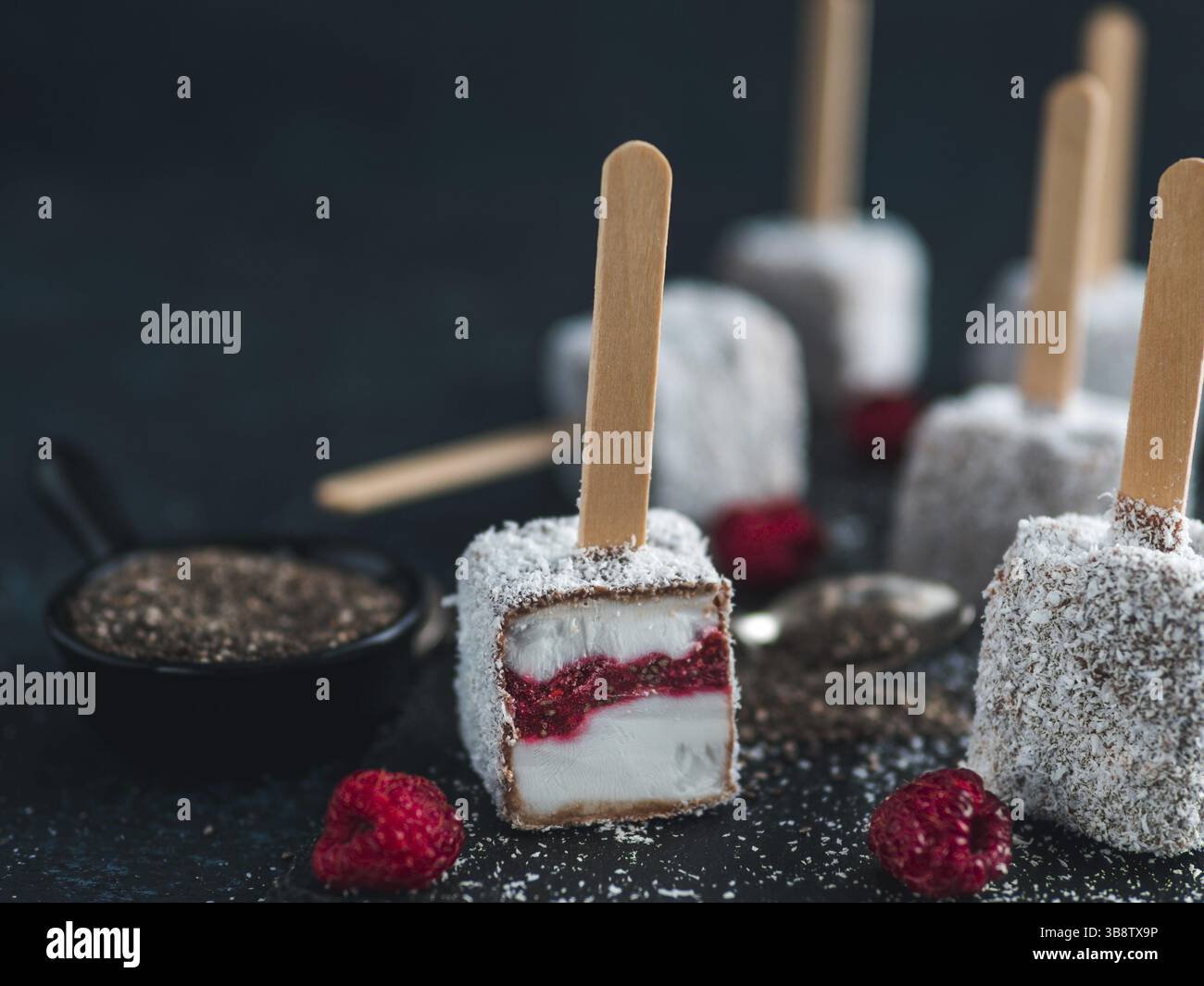 Homemade raw lamington ice cream pops on dark background. Australian ...