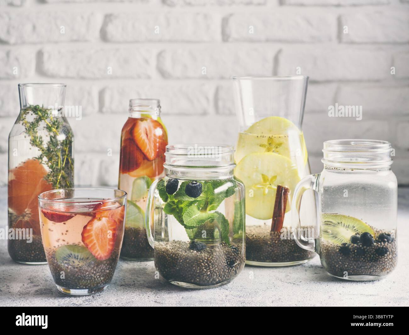 Different chia water in glass on gray background. Chia infused detox ...