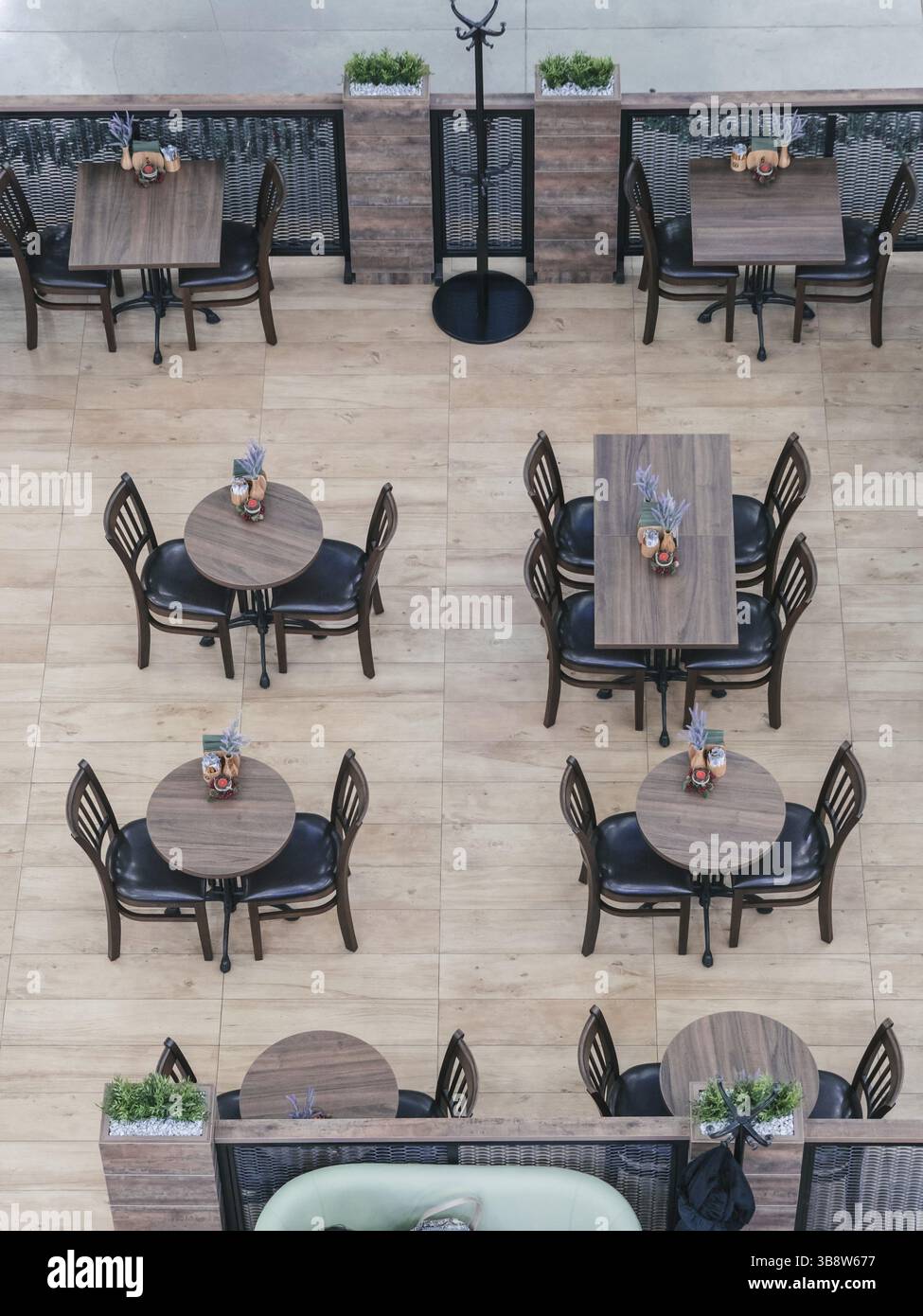 Above view of cafe with empty tables and chairs in shopping mall. Top ...