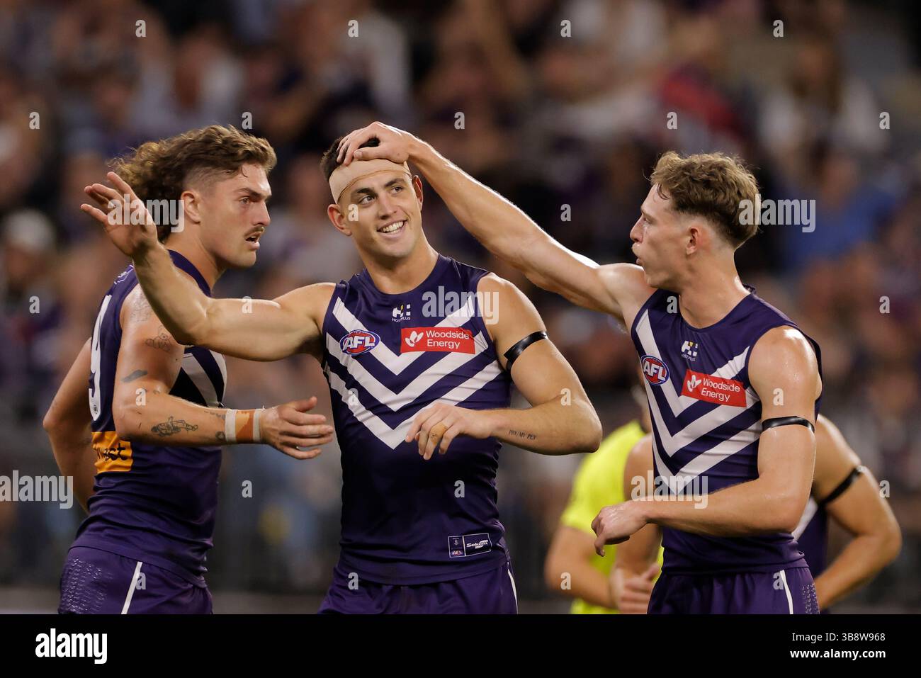 Patrick Voss of the Dockers is congratulated by teammates after kicking ...