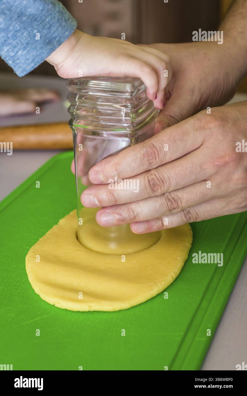 Children and dad hands cook the circles of shortcrust dough Stock Photo ...