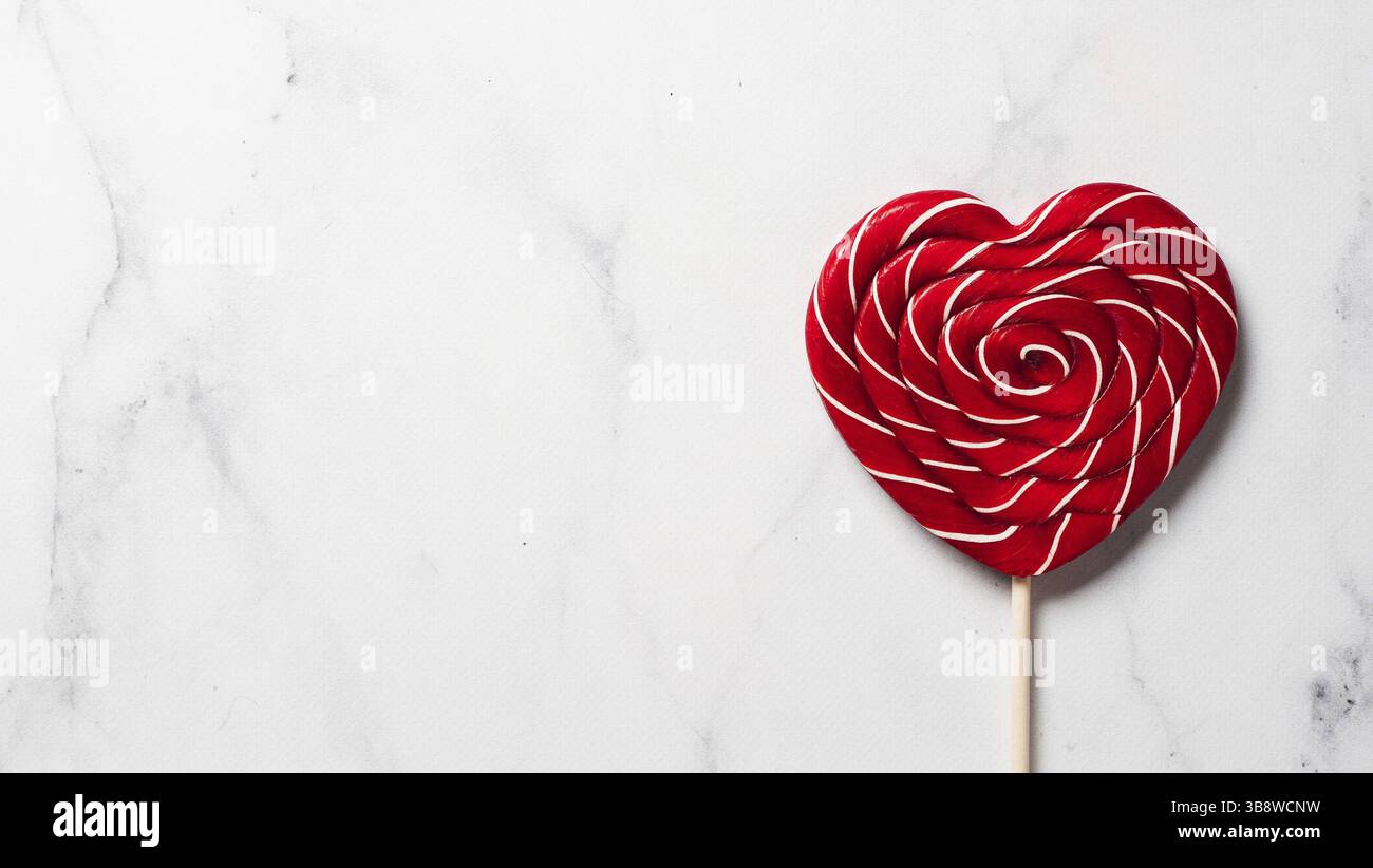 Sweet candy heart on white marble background. copy space left. Top view ...